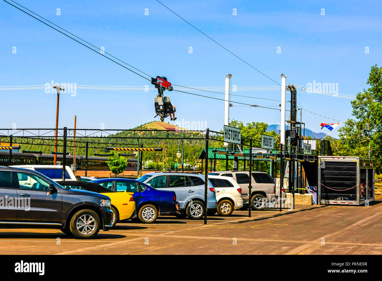People enjoying the thrill of a zip-line set high above a car park ...