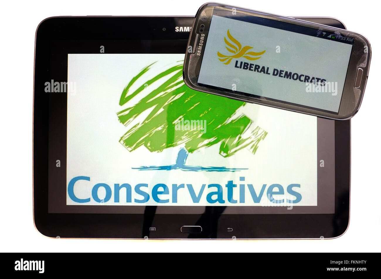The Liberal Democrat and Conservative logos displayed on the screens of ...