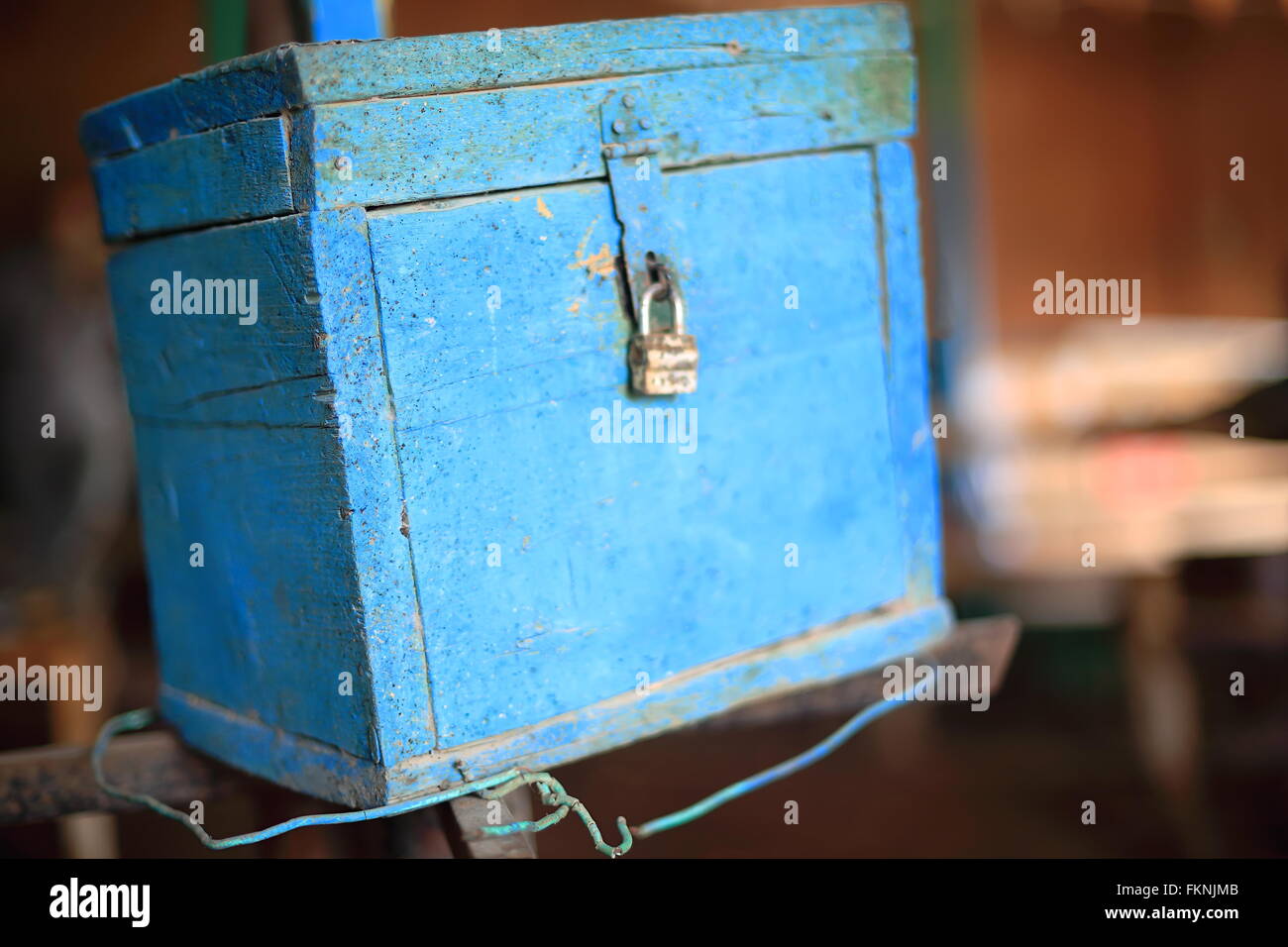 Blue painted wooden christian orthodox donation box with padlock placed ...