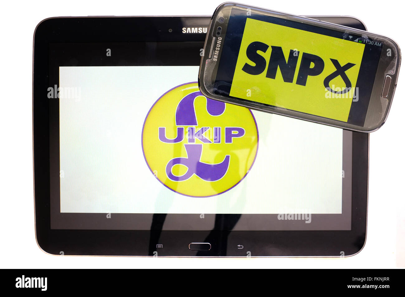 The UKIP and SNP logos displayed on the screens of a tablet and a ...