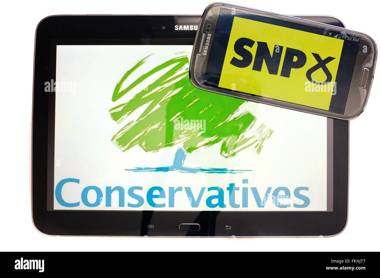 The Conservative and SNP logos displayed on the screens of a tablet and ...