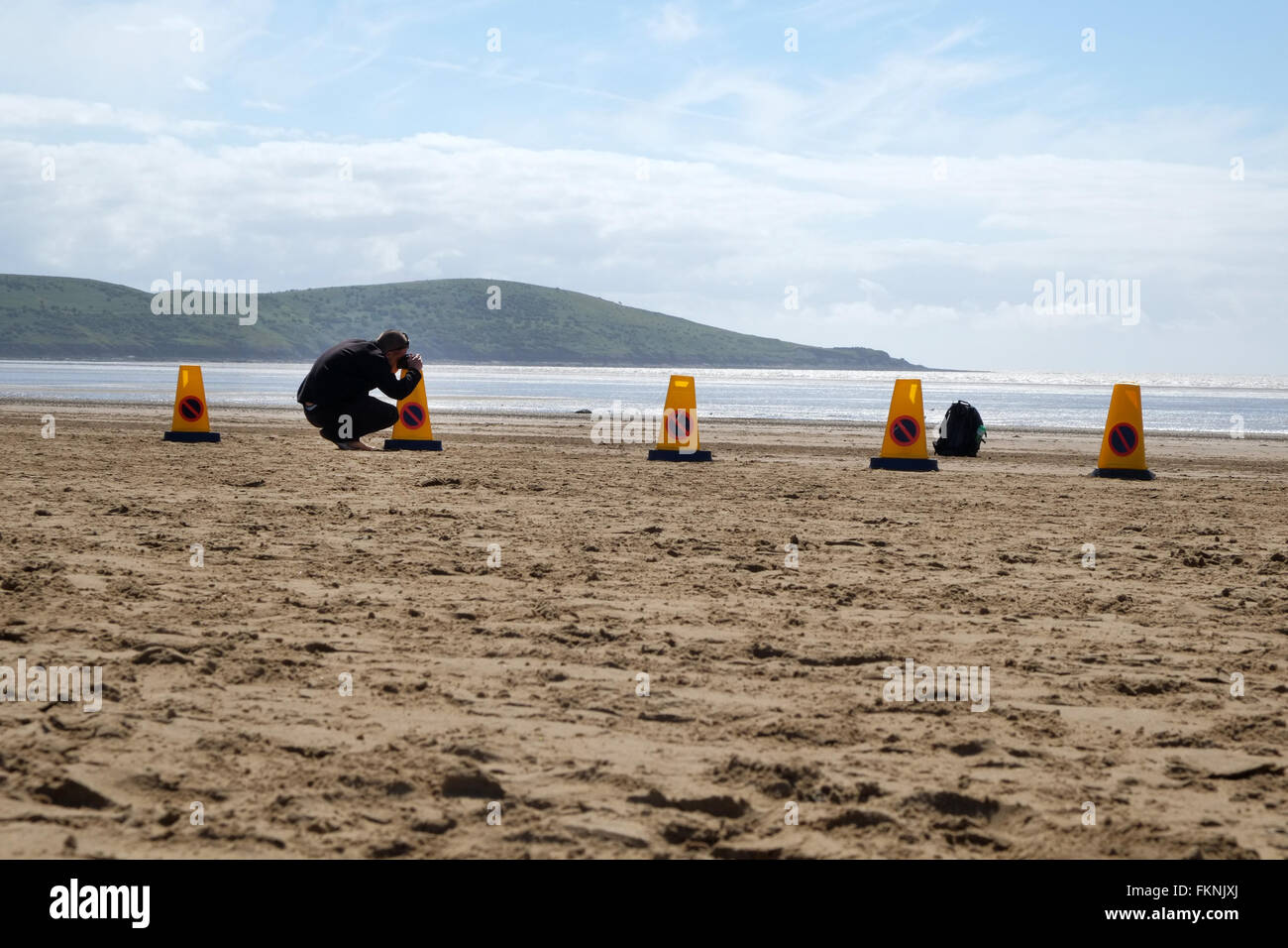 Young guy setting up his camera ready to take a selfie using his self ...