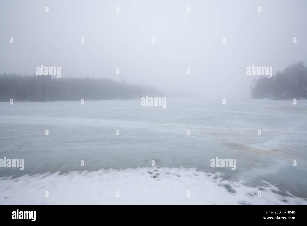Thick fog at frozen lake landscape Stock Photo - Alamy