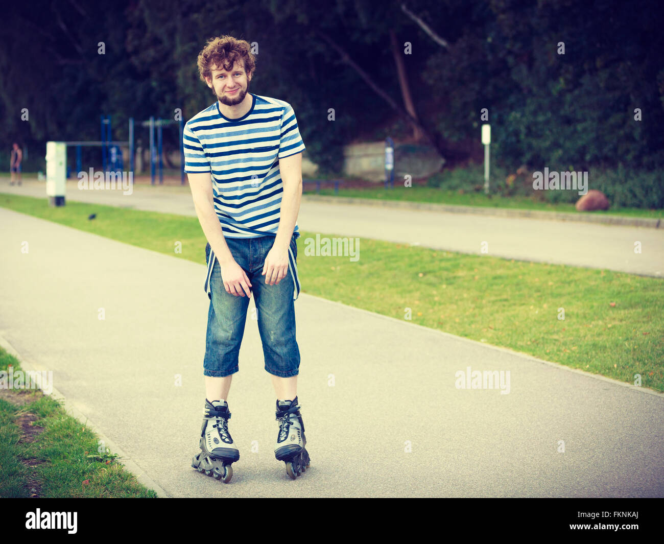 Holidays, active lifestyle freedom concept. Young fit man on roller ...