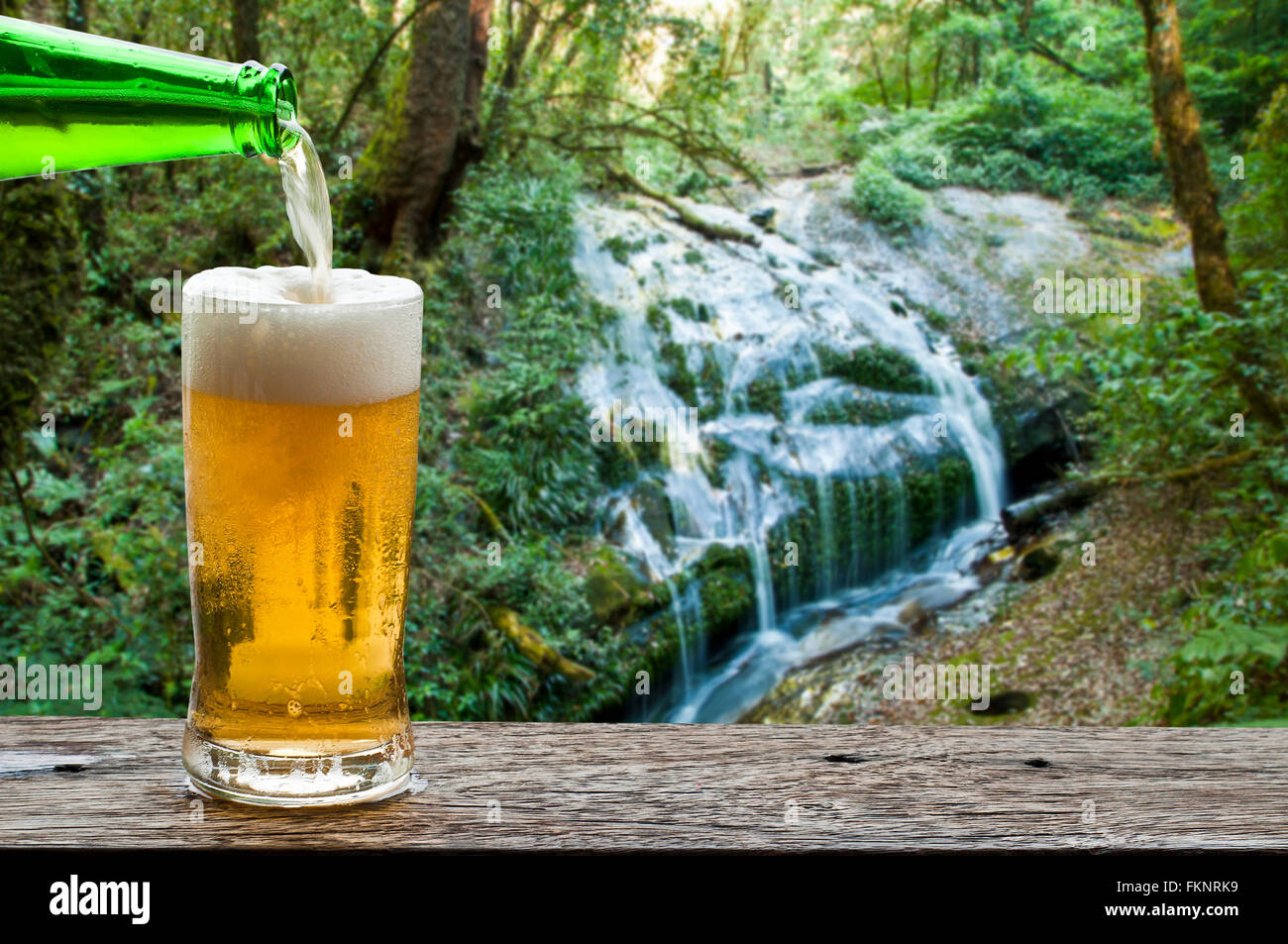 Enjoy beer with waterfall landscape Stock Photo - Alamy