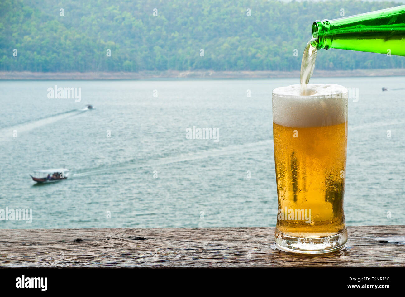 Enjoy beer with lake landscape Stock Photo - Alamy