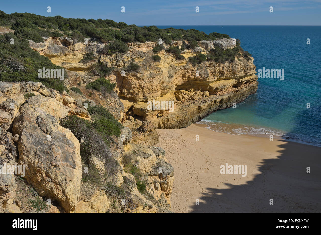 Beach waves lightly touching the sands in Fontainhas beach. Algarve ...