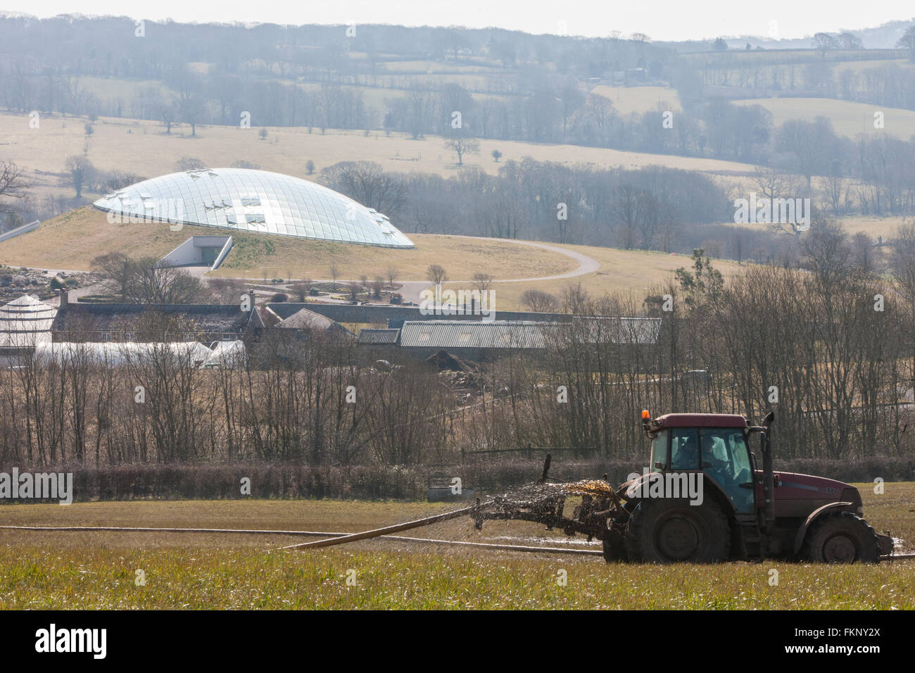 Tractor putting,spraying manure,muck spreading on field and National ...