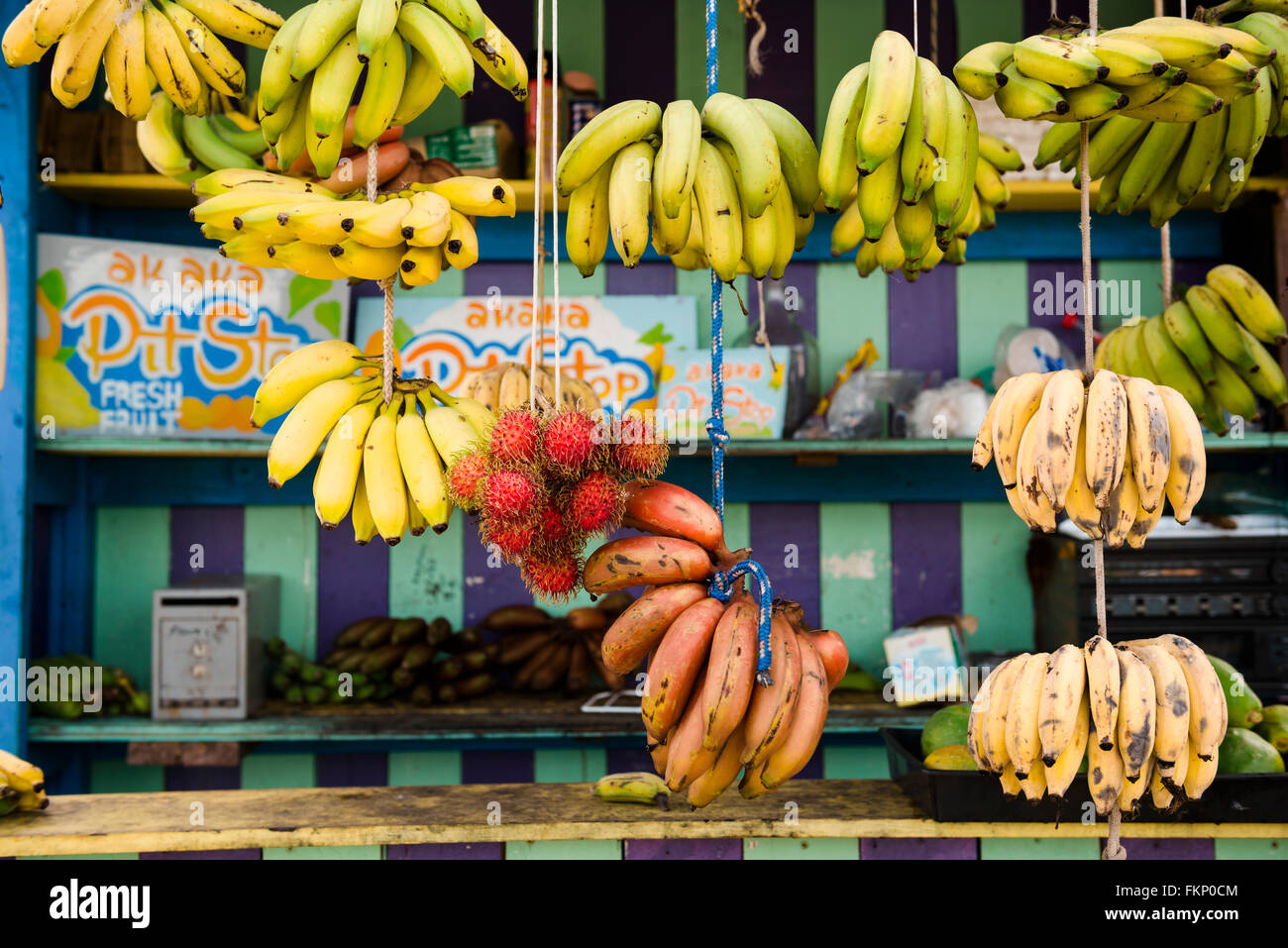 A variety of local fruits hang in a fruit stand on the road near Akaka ...