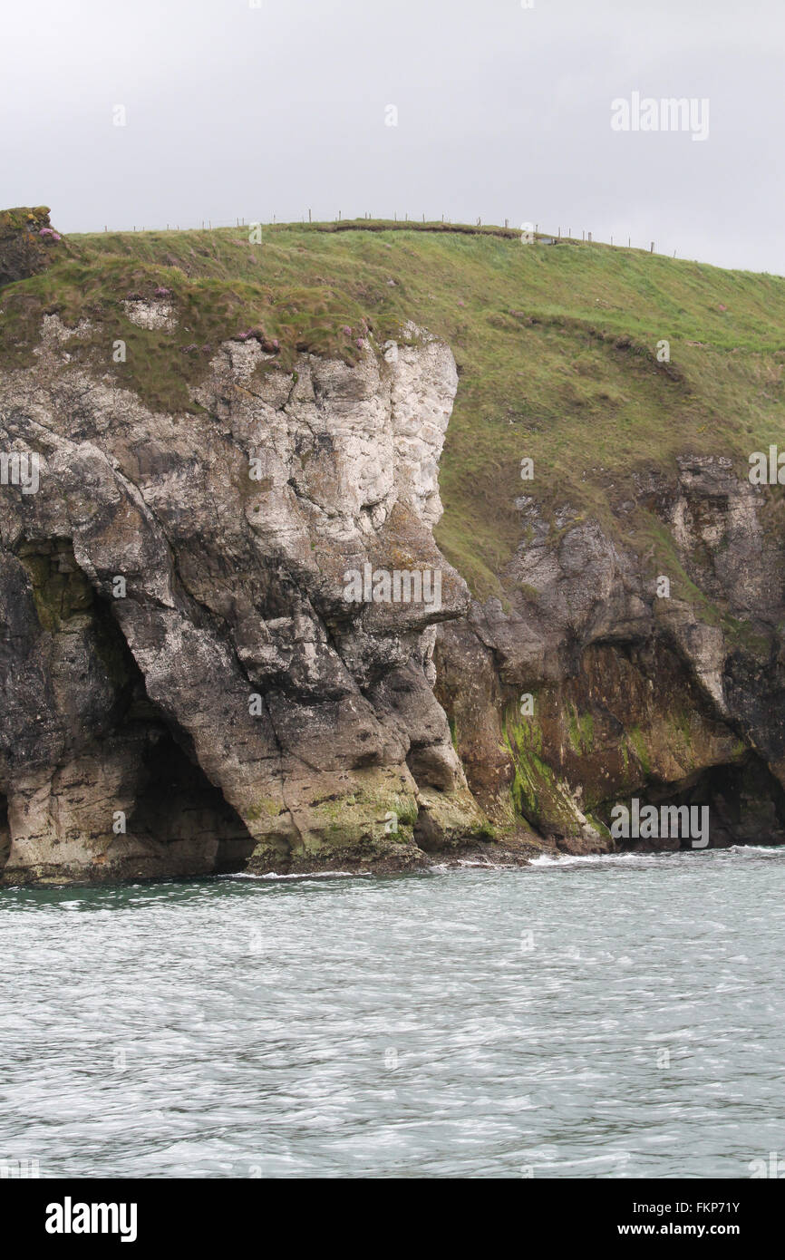 Rock formation resembling human face at limestone sea cliffs on north ...