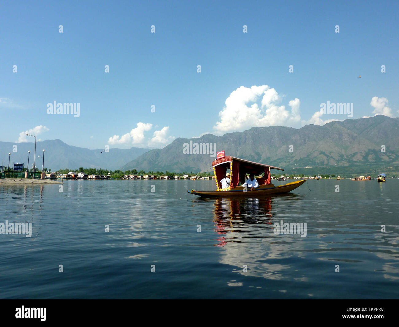 Shikara ride in Dal Lake, Srinagar, Kashmir, with distant view of House ...