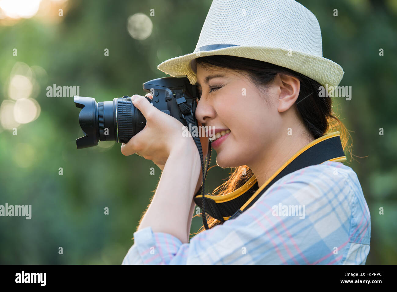 Beautiful asian girl smiling with digital camera photographing, outdoor ...