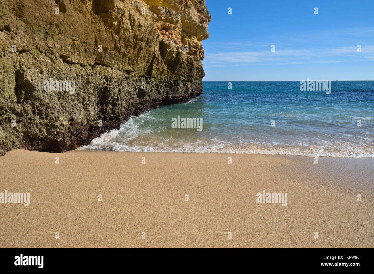 Beach waves lightly touching the sands in fontainhas beach algarve hi ...