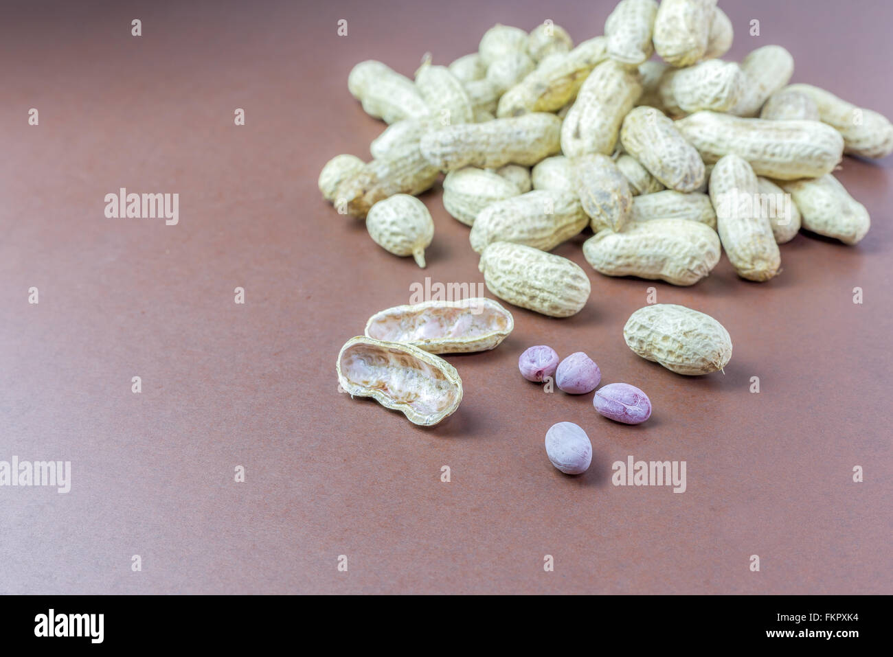 peanuts with shell on brown paper Stock Photo - Alamy