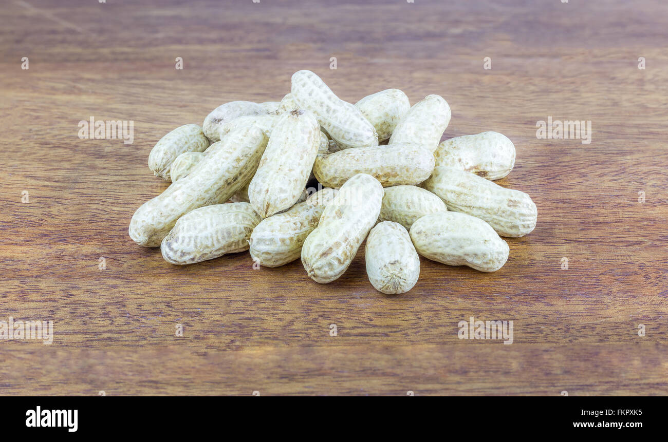 peanuts with shell on wood table Stock Photo - Alamy