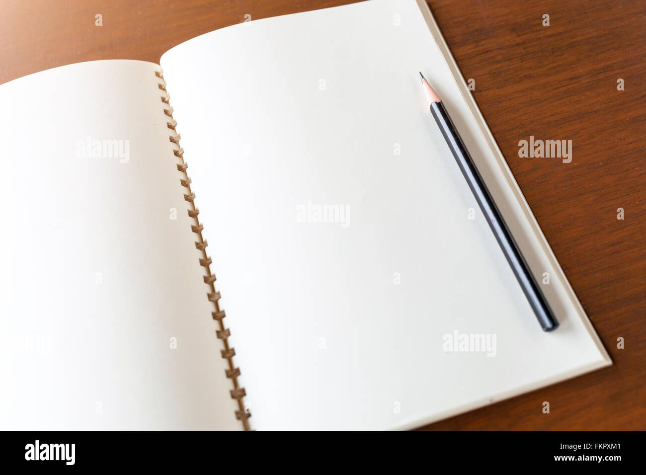 Blank note book with pencil on wooden table background concept and Idea ...