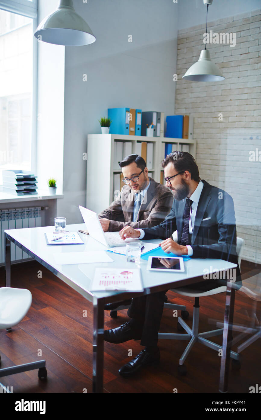Business partners discussing financial issues Stock Photo - Alamy