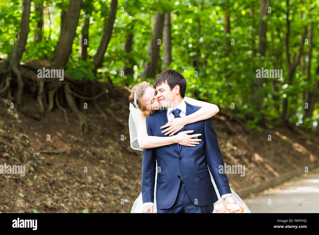 Wedding, Beautiful Romantic Bride and Groom Embracing Stock Photo - Alamy