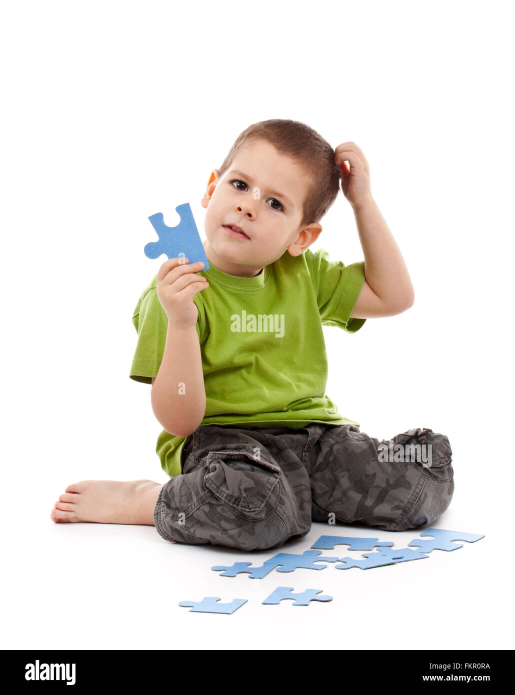 Boy with puzzles scratches his head and thinking Stock Photo - Alamy