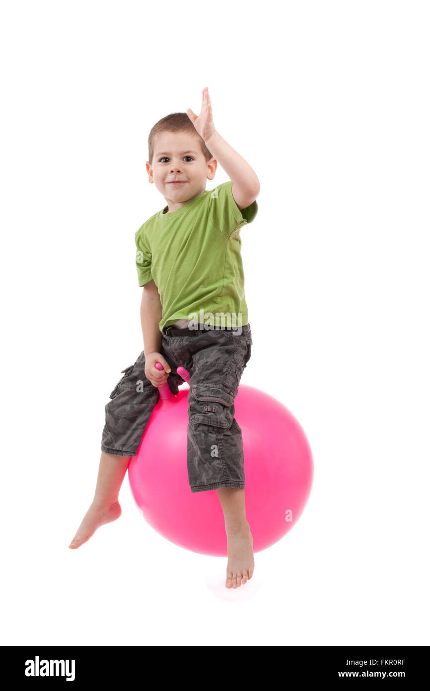 Boy jumping on a large ball Stock Photo - Alamy