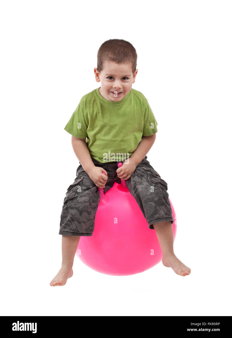 Boy jumping on a large ball Stock Photo - Alamy