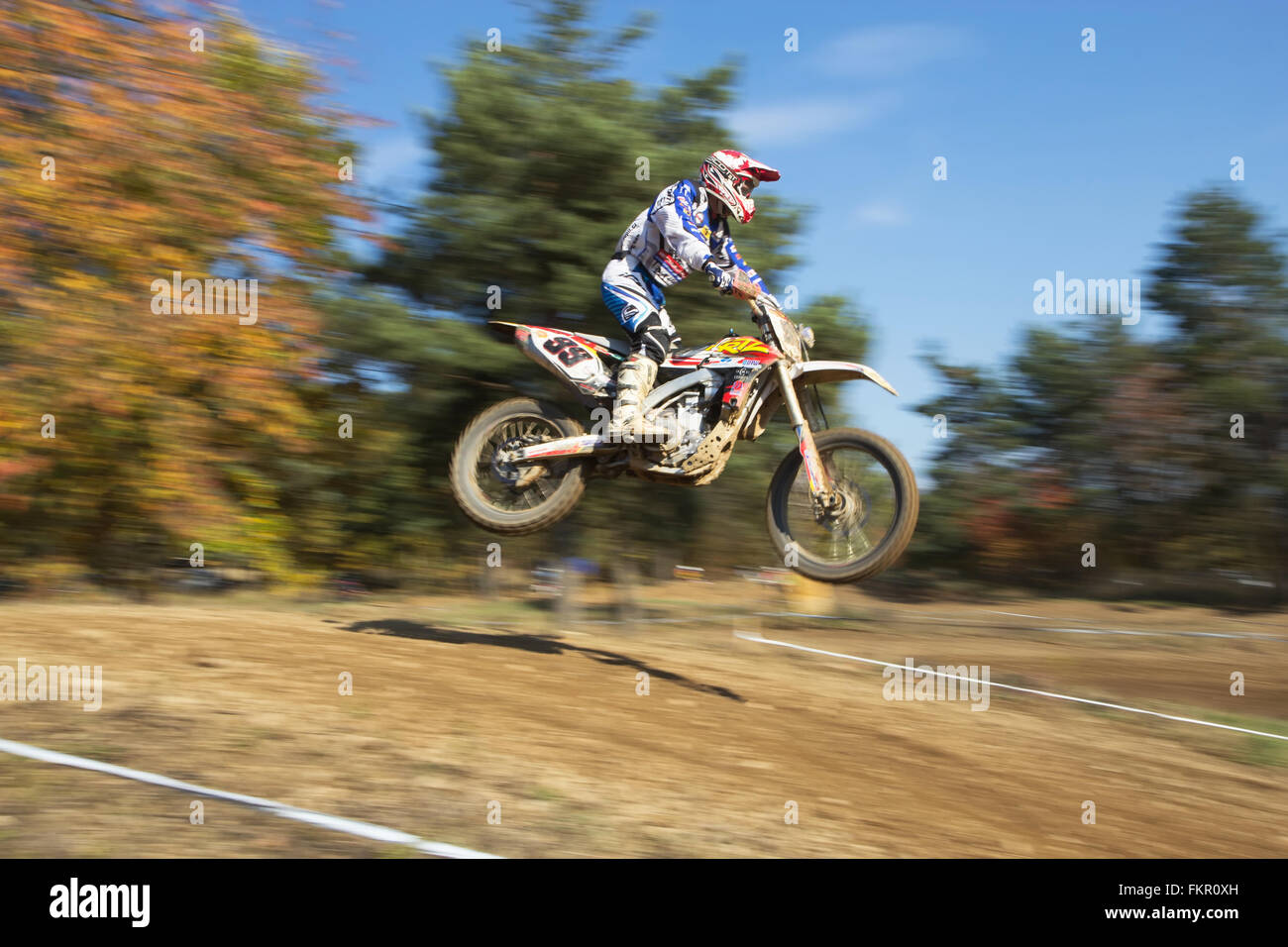 Motocross rider is jumping Stock Photo - Alamy