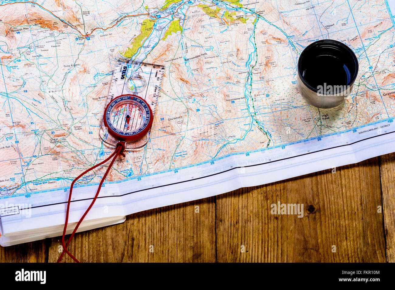 Checking route on a map with a drink Stock Photo - Alamy