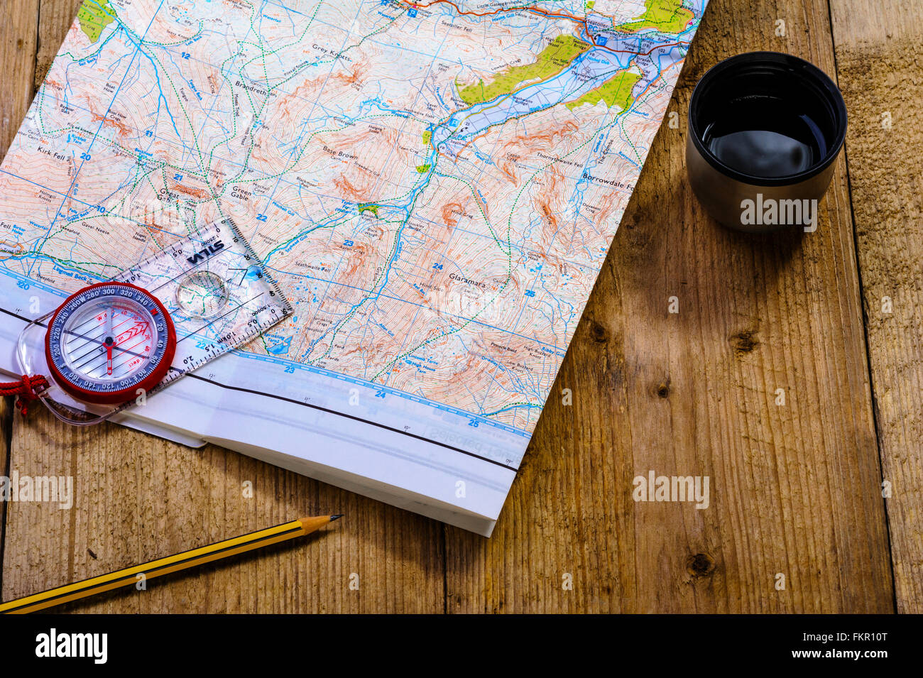 Checking route on a map with a drink Stock Photo - Alamy