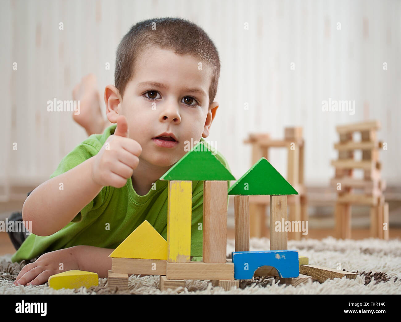 little boy building a house with colorful wooden blocks Stock Photo - Alamy
