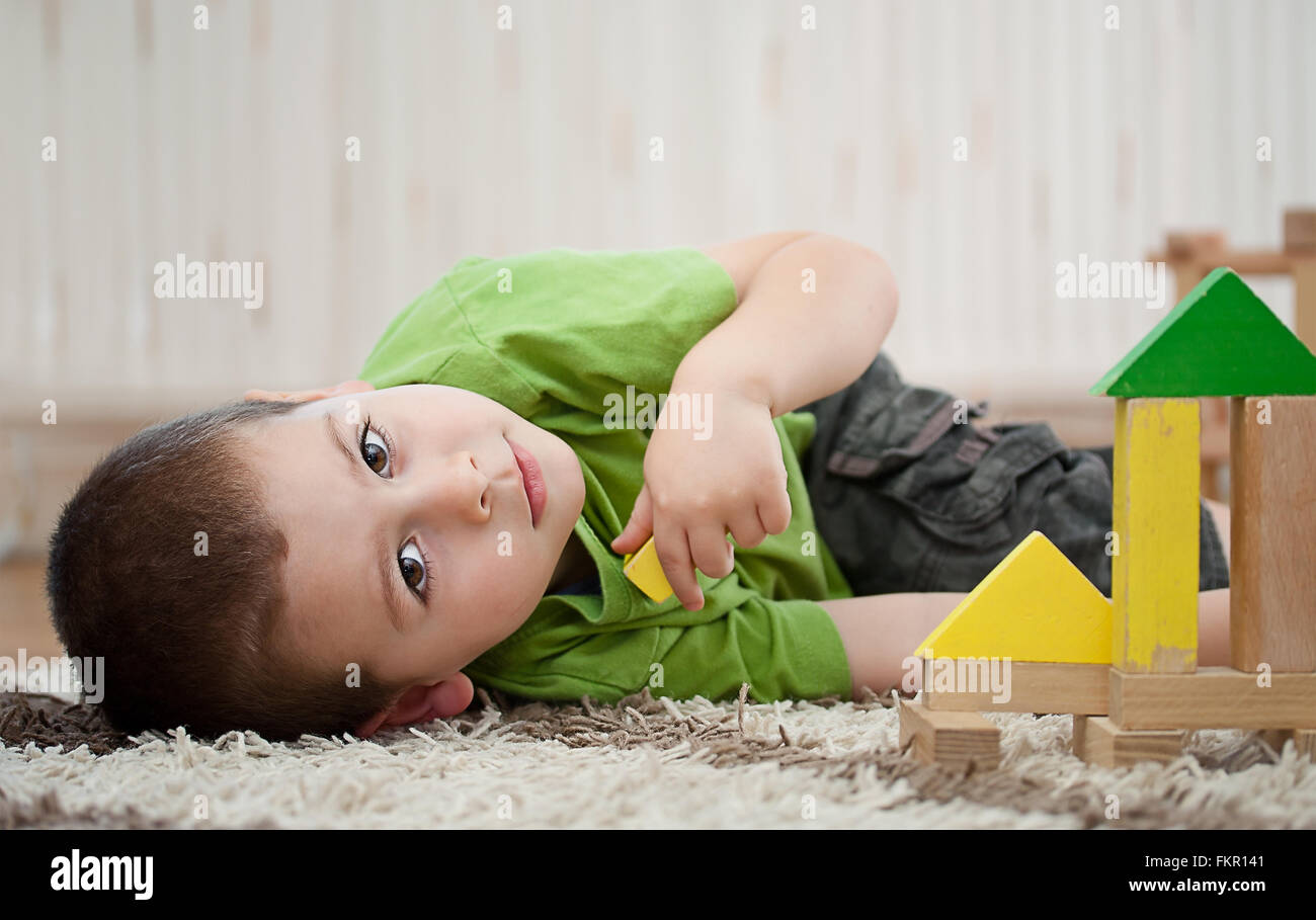 little boy building a house with colorful wooden blocks Stock Photo - Alamy