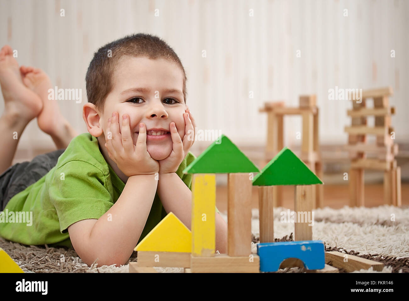 little boy building a house with colorful wooden blocks Stock Photo - Alamy