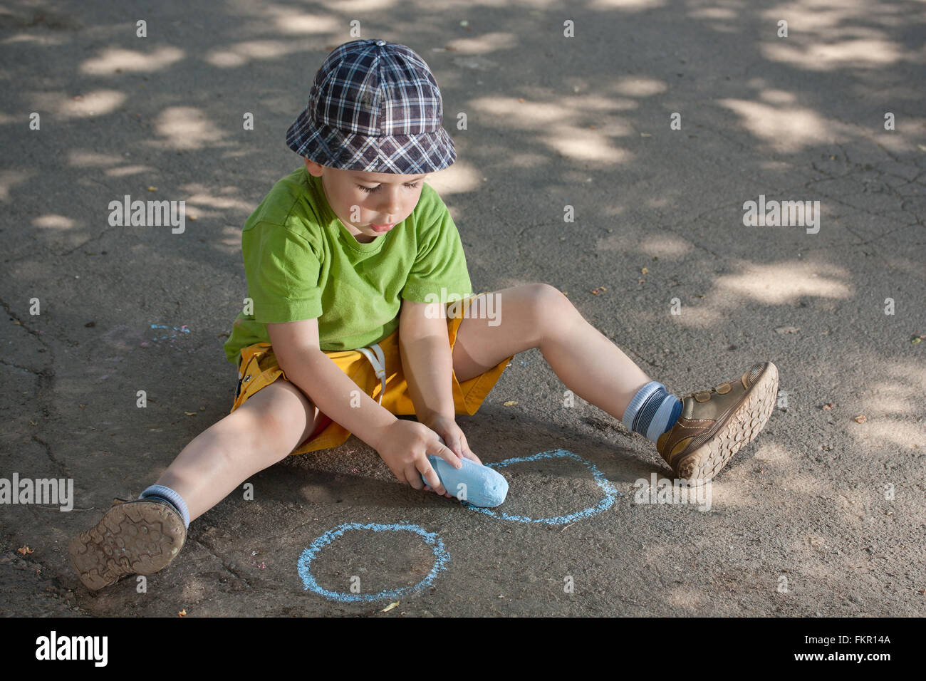 Boy drawing with chalk on asphalt Stock Photo - Alamy