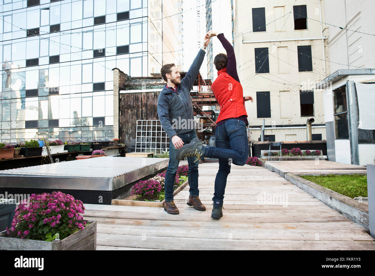 Couple dancing on urban rooftop Stock Photo - Alamy