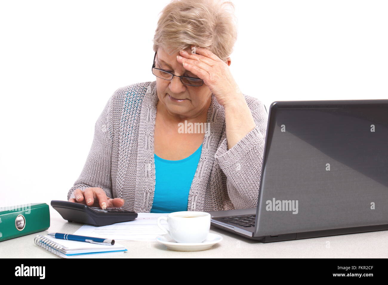 Worried senior woman, an elderly pensioner counting utility bills at ...