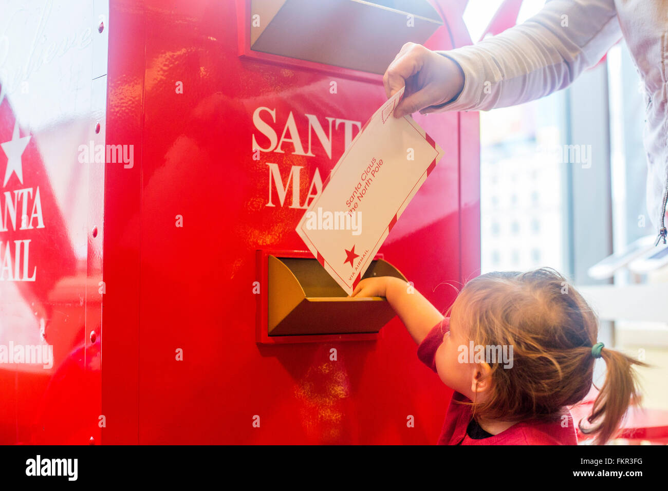 Caucasian mother and daughter mailing letter to Santa Stock Photo - Alamy