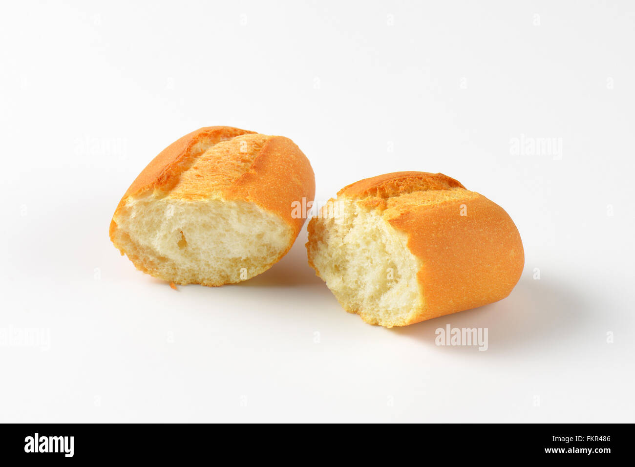 halved fresh bread roll on white background Stock Photo - Alamy