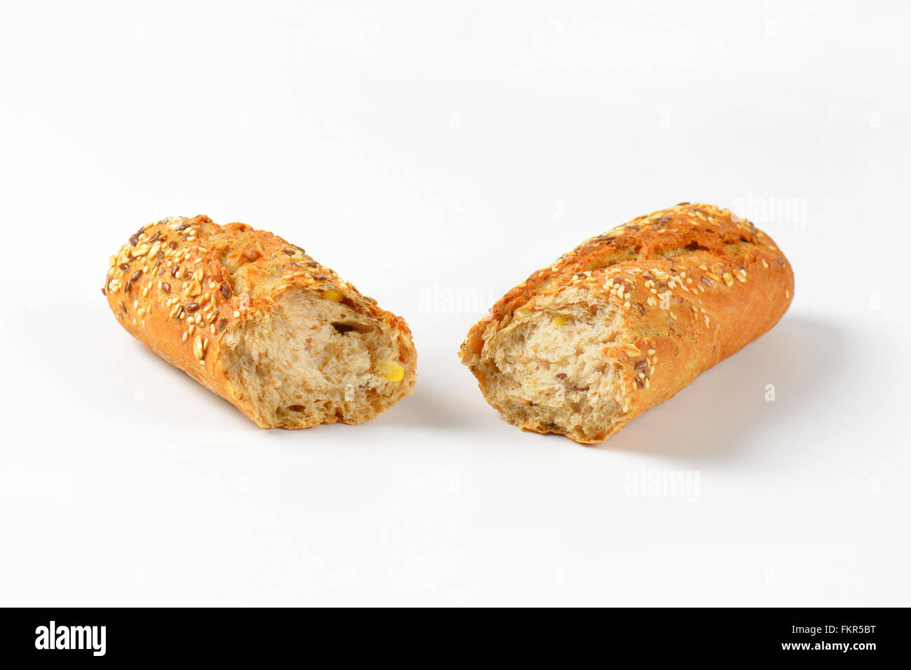 halved bread roll with seeds on white background Stock Photo - Alamy