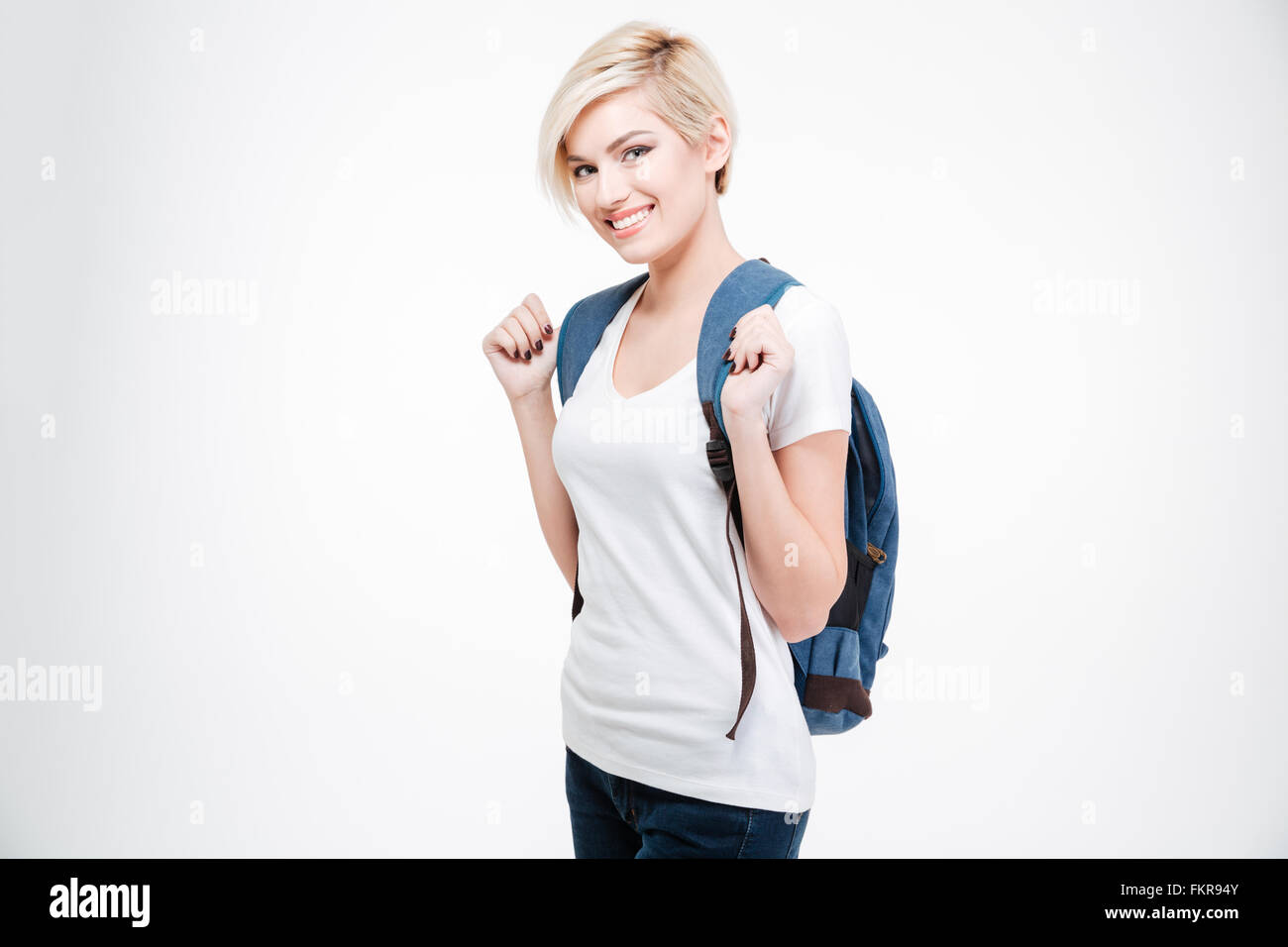 Happy female student with backpack standing isolated on a white ...