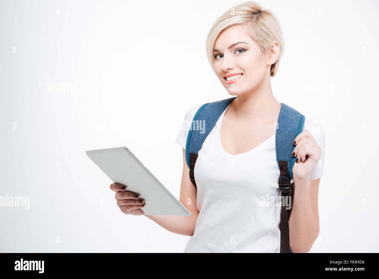 Female student holding tablet computer and looking at camera isolated ...