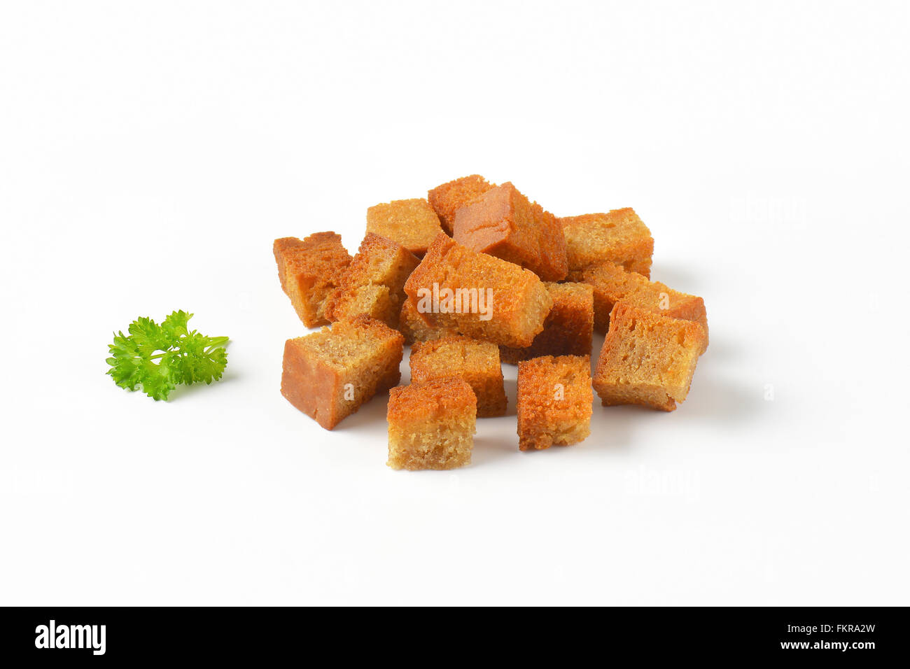 handful of fried bread cubes (croutons) on white background Stock Photo ...