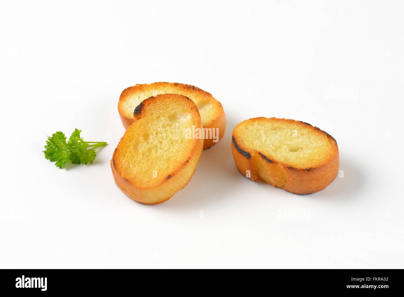 three fried bread slices on white background Stock Photo - Alamy