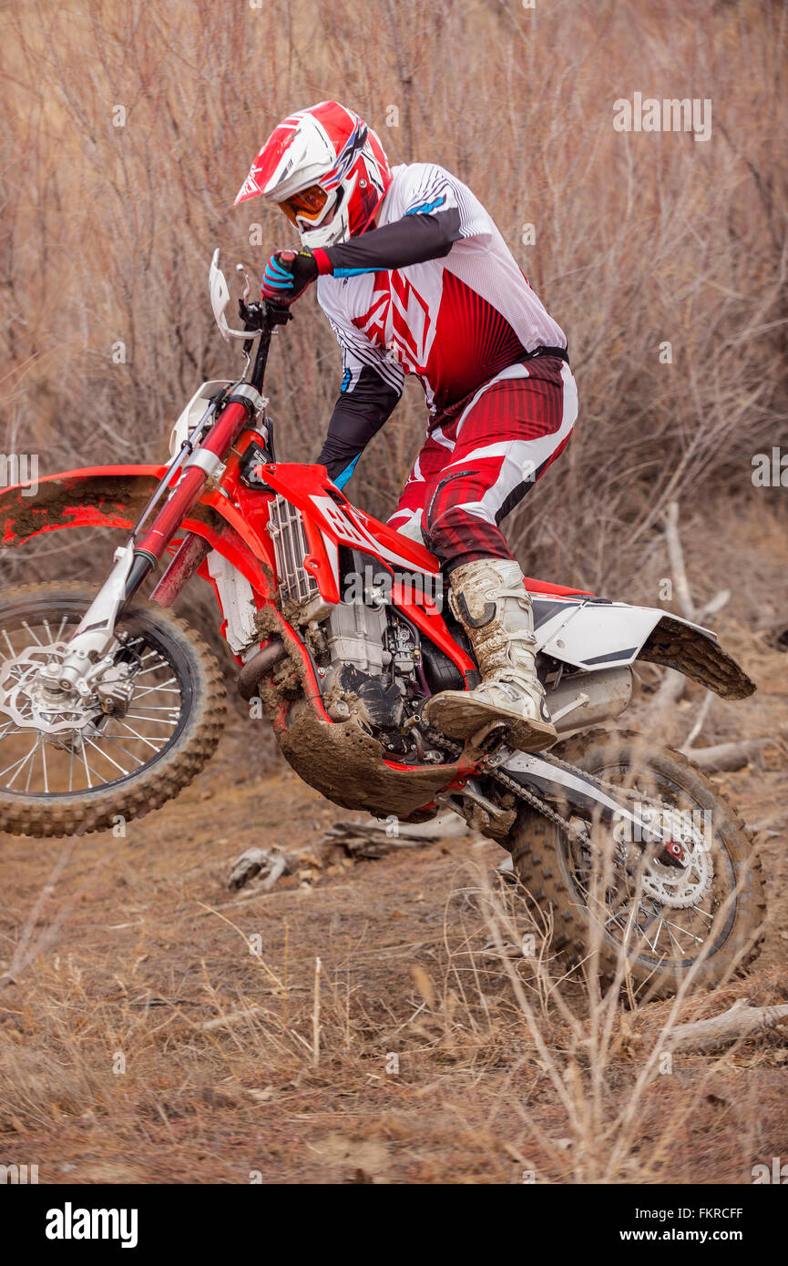 Motorcyclist riding dirt bike on rural path Stock Photo - Alamy