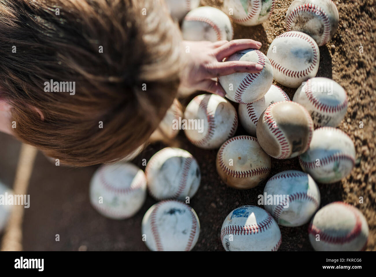 Boy picking up a ball hi-res stock photography and images - Alamy