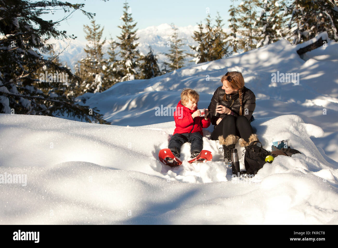 Caucasian mother and son drinking hot cocoa in snow Stock Photo - Alamy