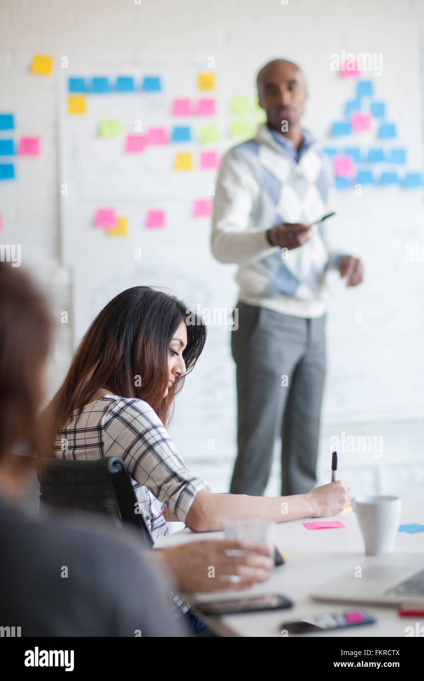 Business people writing notes in office meeting Stock Photo - Alamy