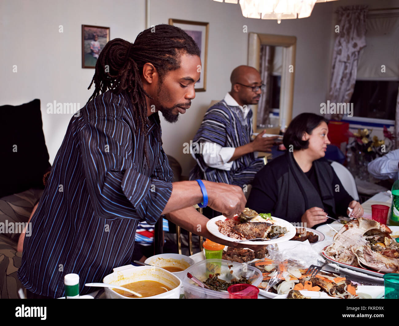 Man serving food at holiday dinner Stock Photo - Alamy