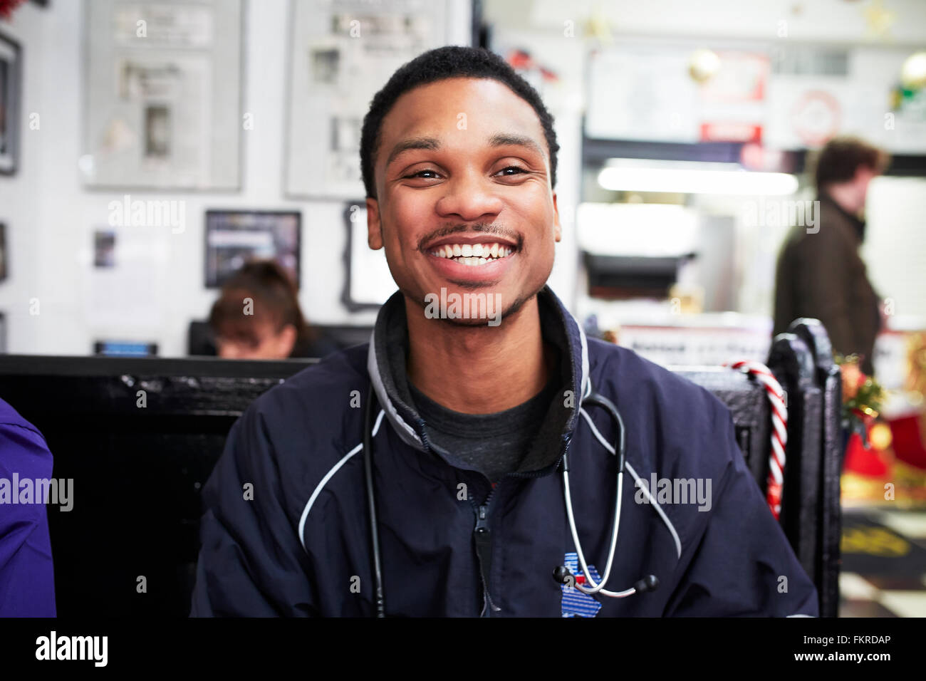 Paramedic smiling in restaurant Stock Photo - Alamy