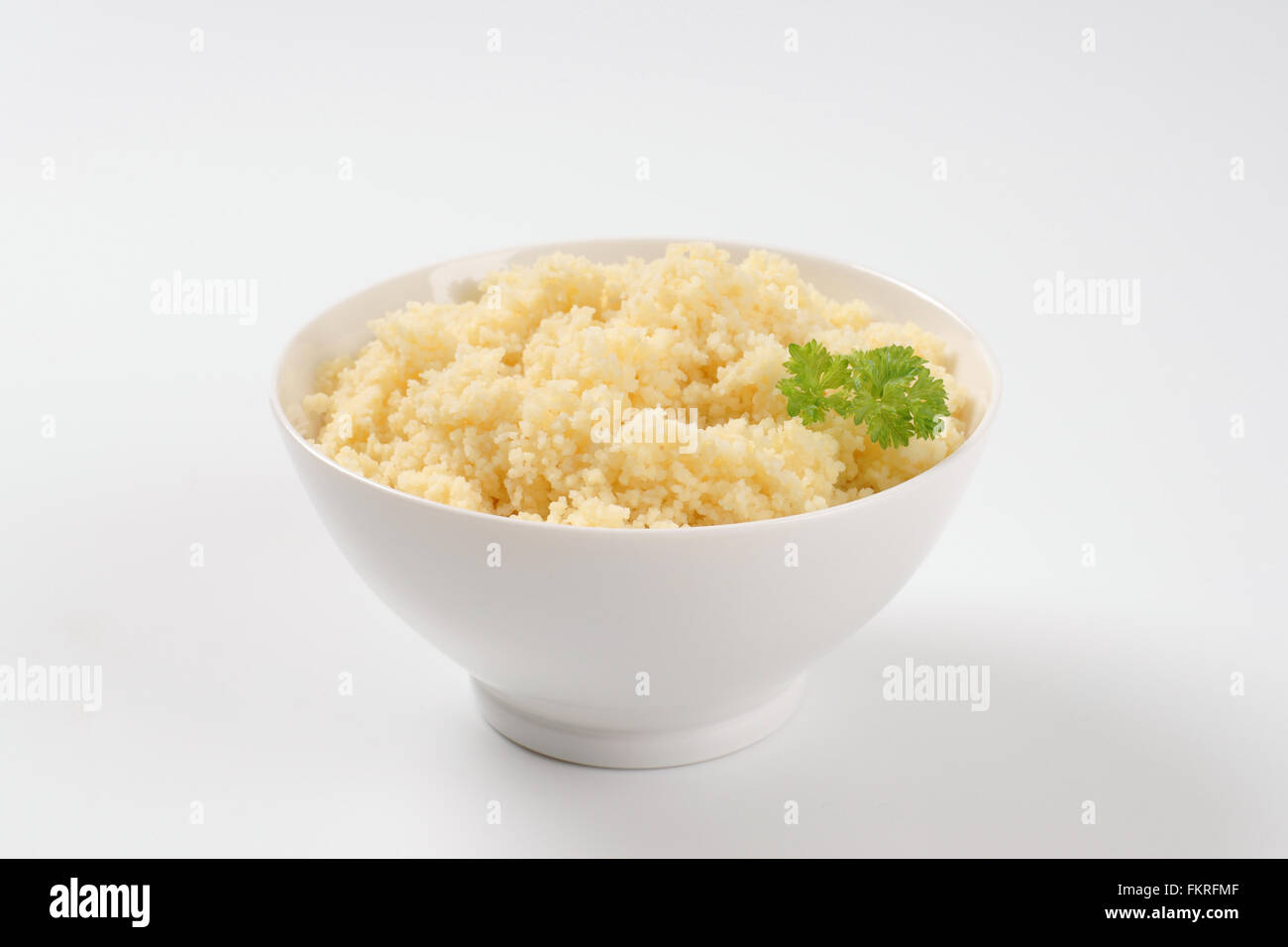 bowl of cooked couscous on white background Stock Photo - Alamy