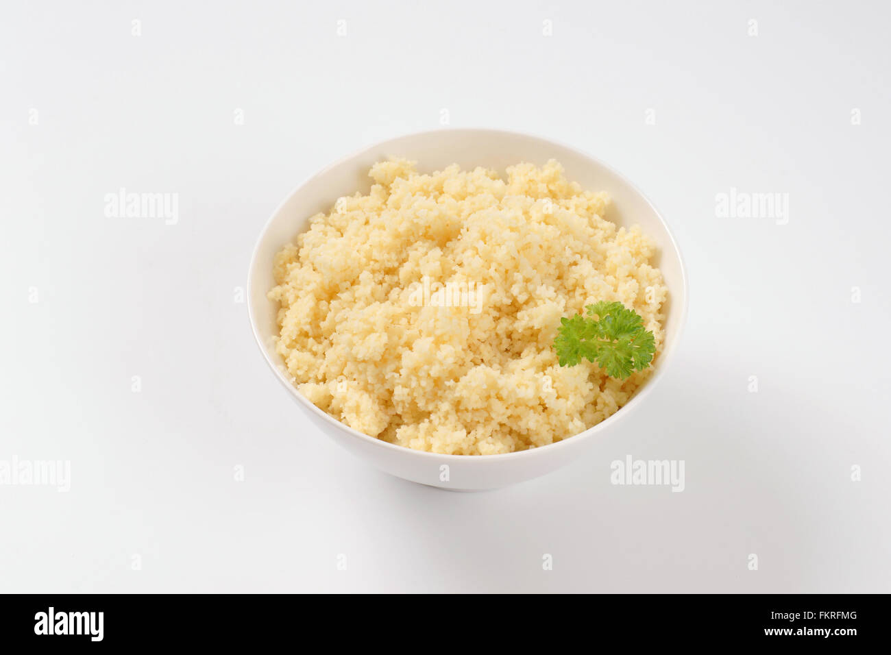 bowl of cooked couscous on white background Stock Photo - Alamy