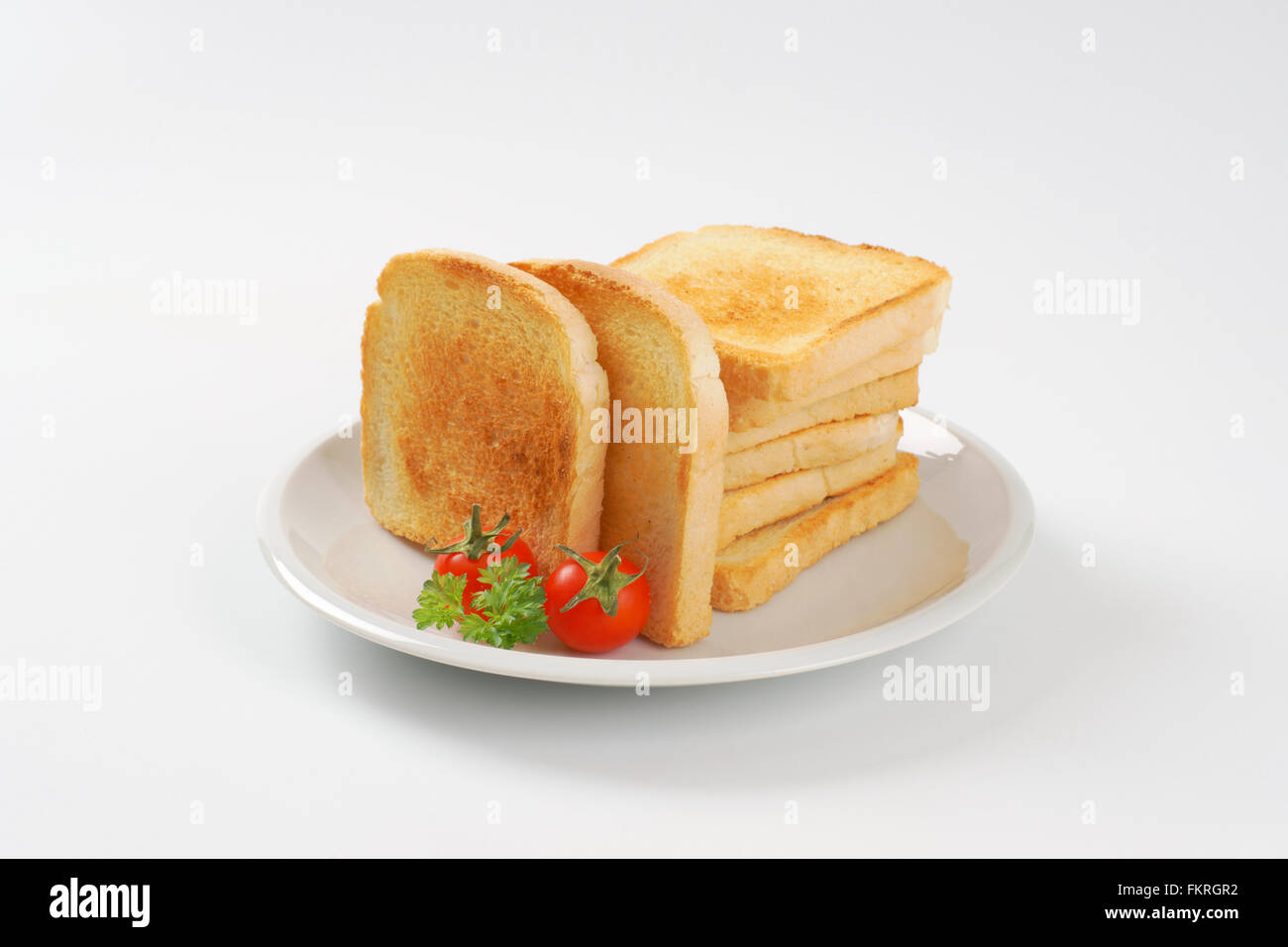 plate of freshly made toasts on white background Stock Photo - Alamy